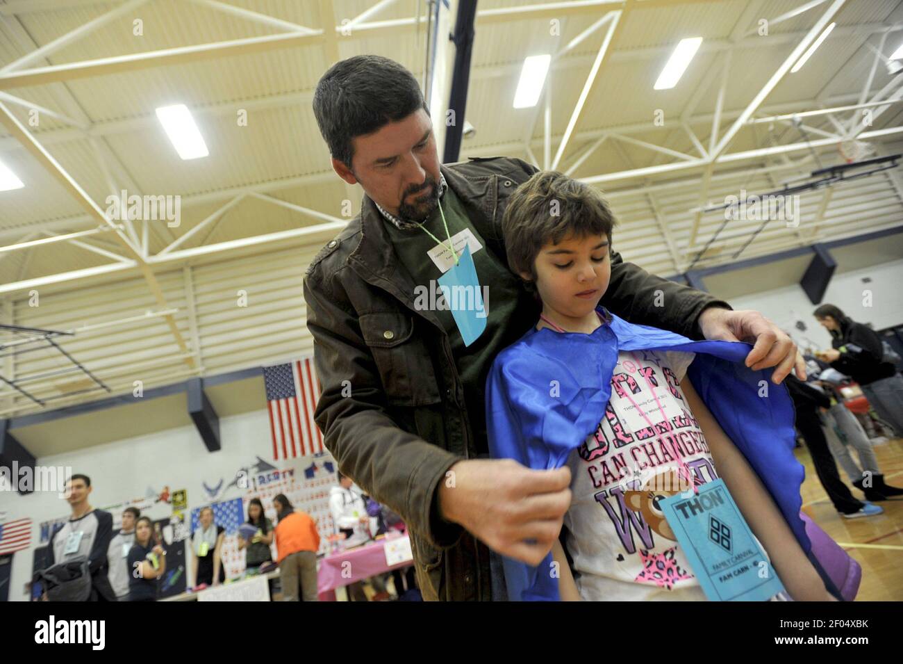 Tom Whitehead puts a cape on his daughter, Emily, at the Thon Carnival ...