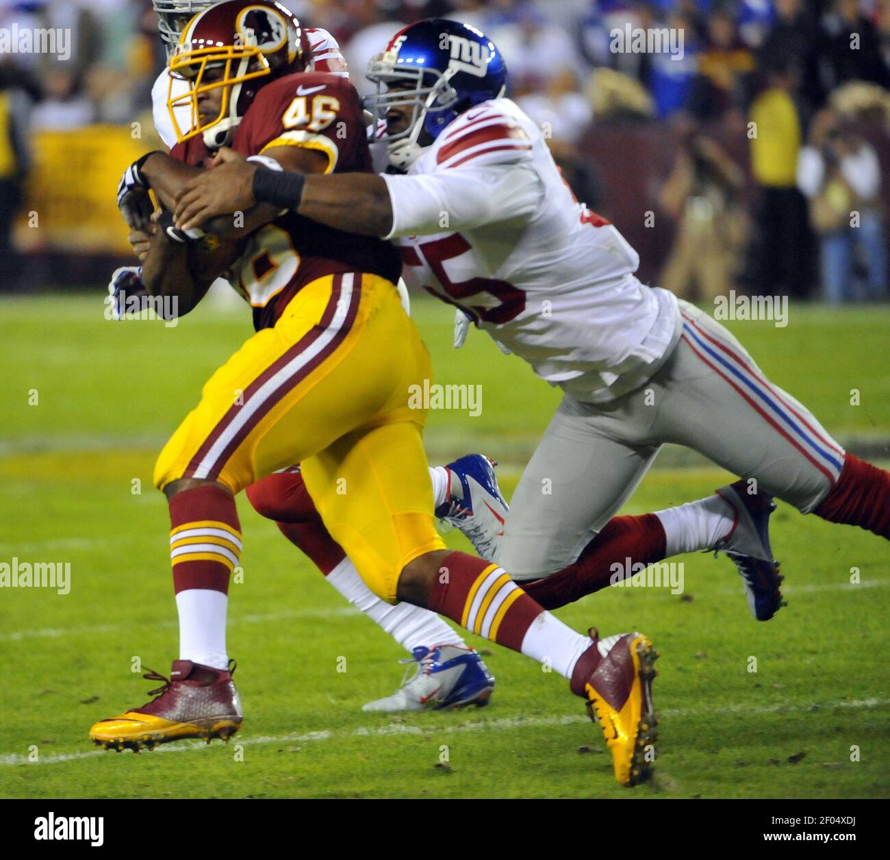 New York Giants outside linebacker Keith Rivers (55) brings down ...