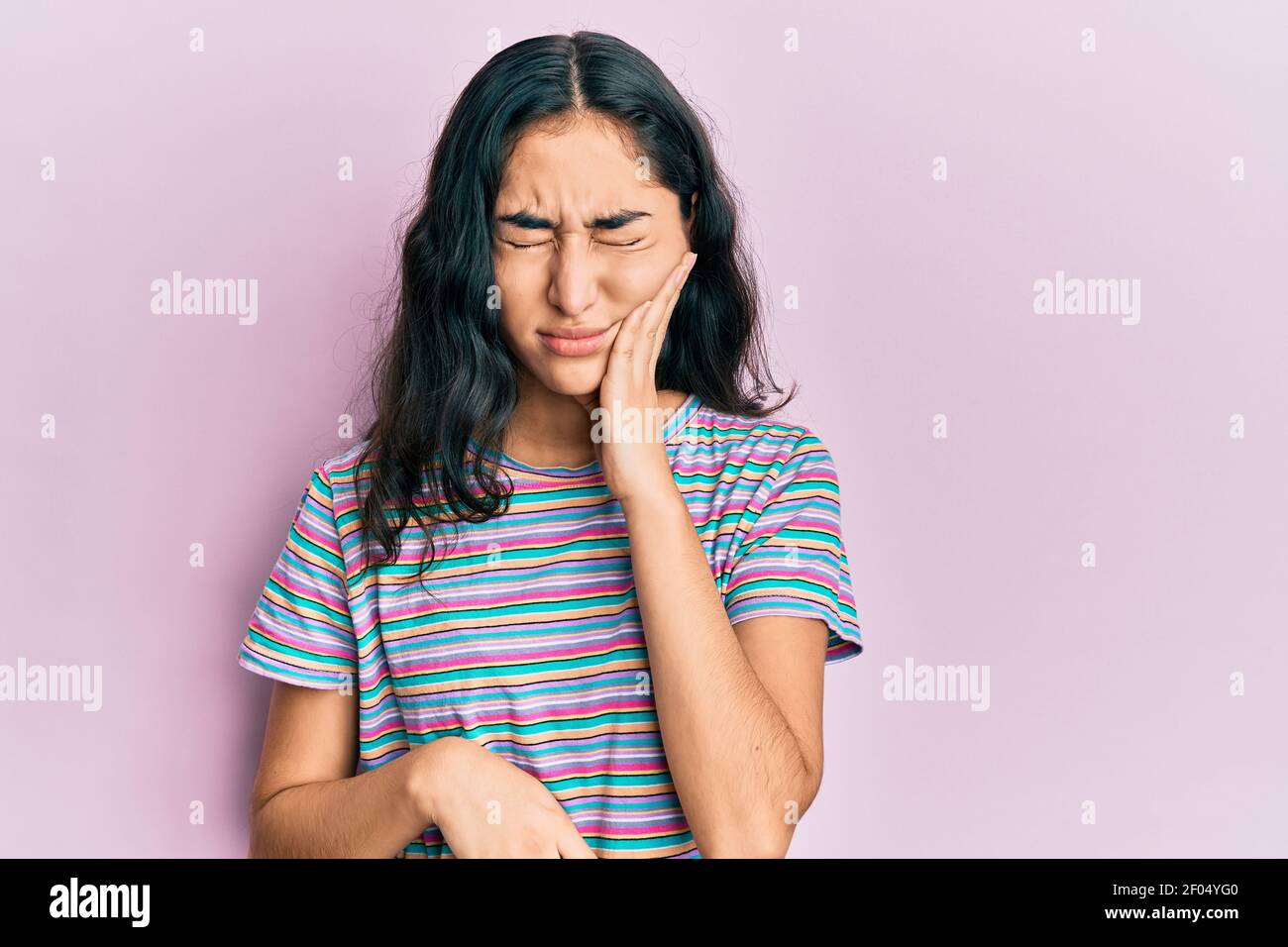 Hispanic teenager girl with dental braces wearing casual clothes ...