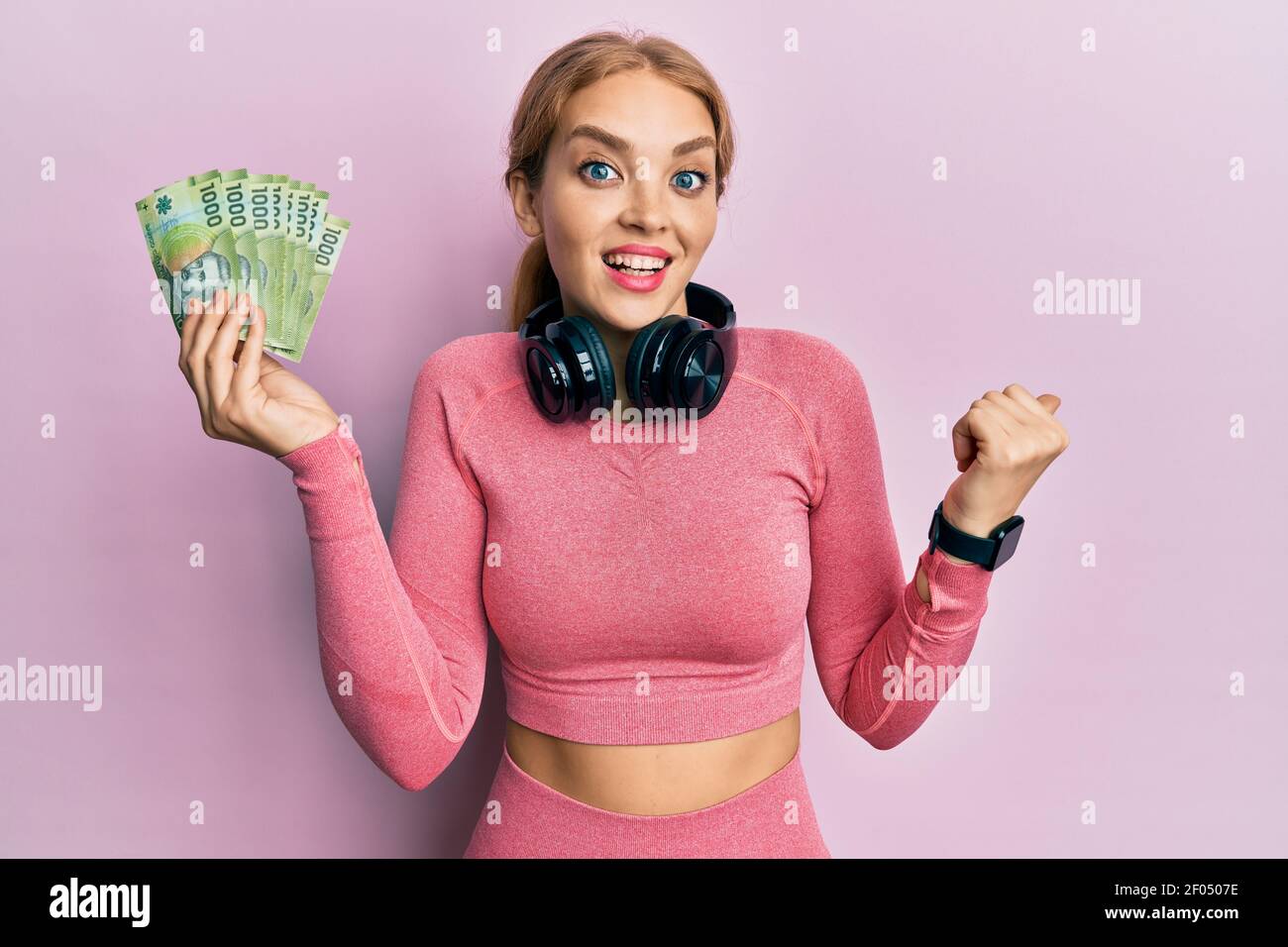 Beautiful blonde caucasian woman wearing gym clothes holding chilean ...