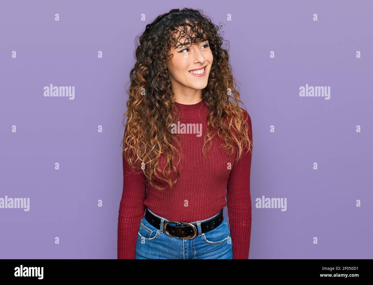 Young hispanic girl wearing casual clothes looking away to side with ...
