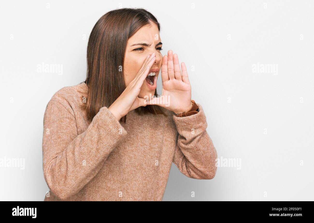 Young beautiful woman wearing casual clothes shouting angry out loud ...