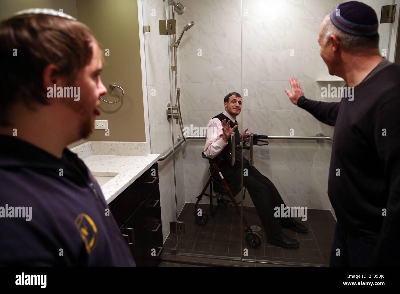 Resident Jacob Mosbacher, 25, left, helps out as Baruch Schur, right ...