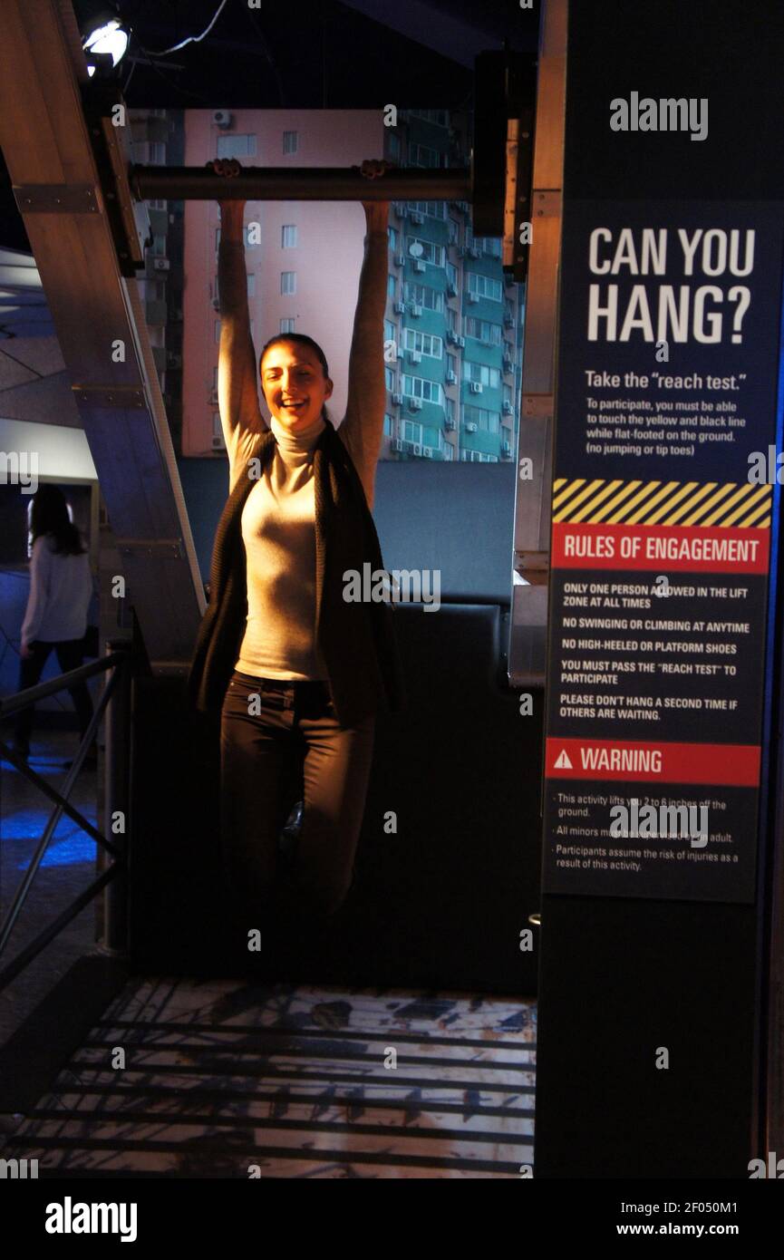 A visitor, Kate Michael, tests one of the interactive exhibits at the ...