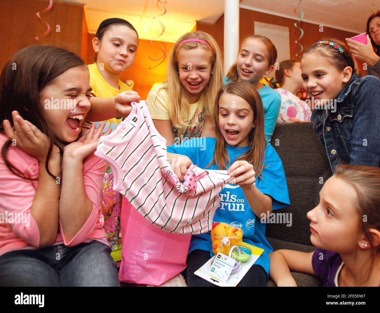 Marissa Friedmann, center, and her friends gush over the gift of a baby ...