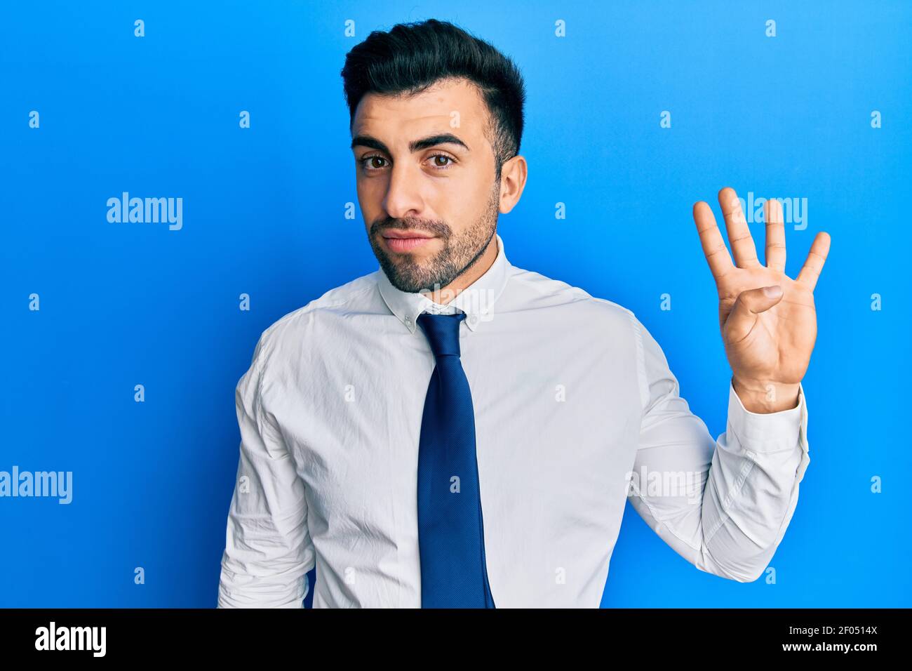 Young hispanic man wearing business clothes showing and pointing up ...