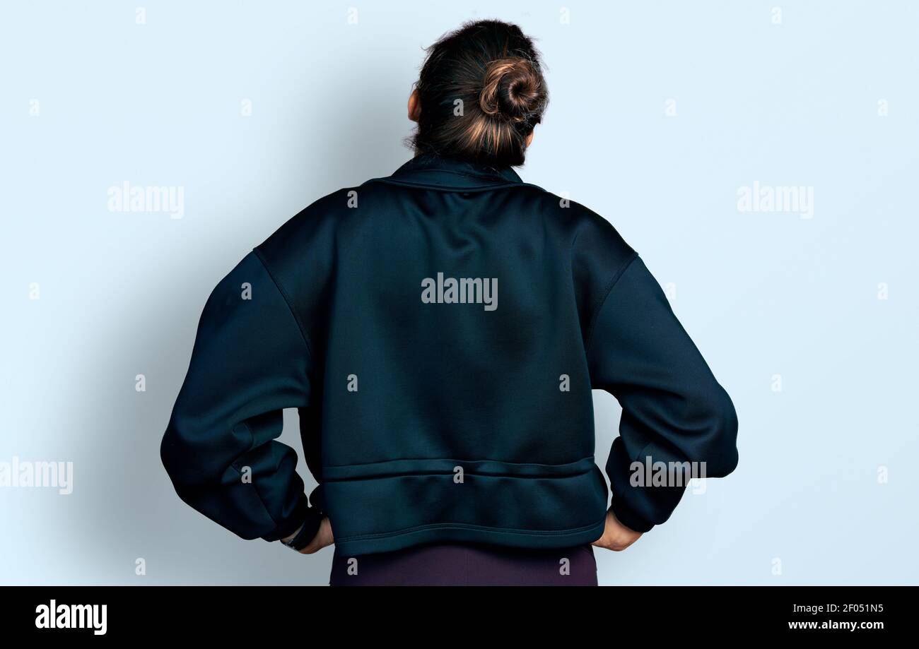 Young Hispanic Girl Wearing Sportswear Standing Backwards Looking Away