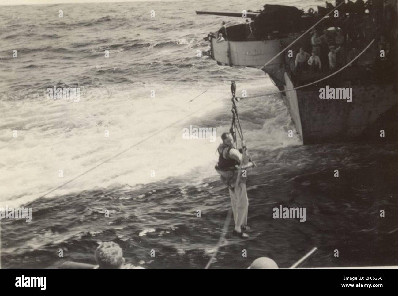 Pilot being transferred from USS O'Flaherty (DE-340) to escort carrier ...