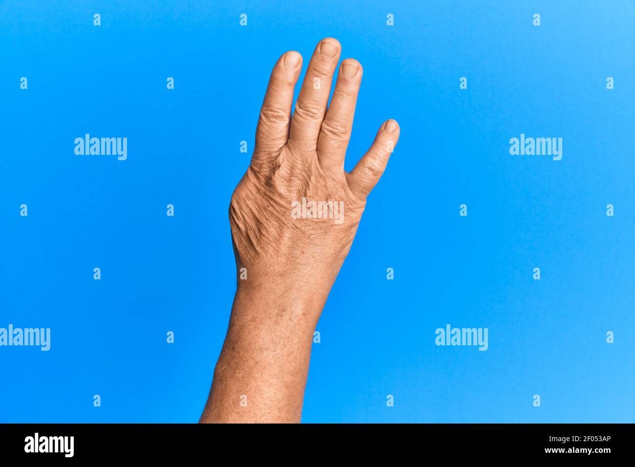Hand of senior hispanic man over blue isolated background counting ...