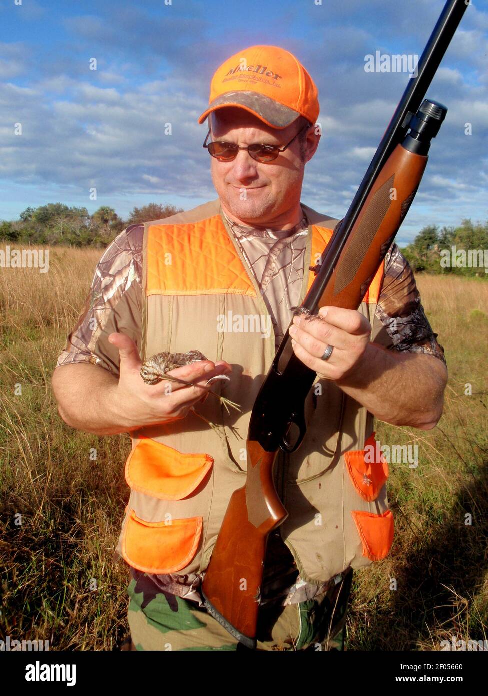Rick Wuest of Tampa, Florida, holds a snipe that he shot during a hunt ...