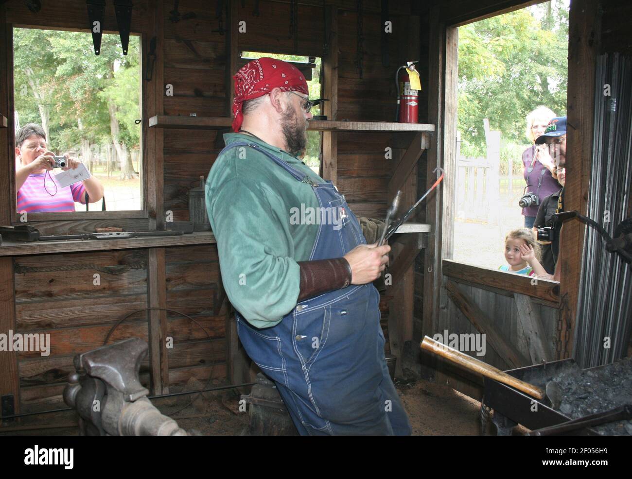 A blacksmith demonstrates his skill in a shed on the Jimmy Carter ...
