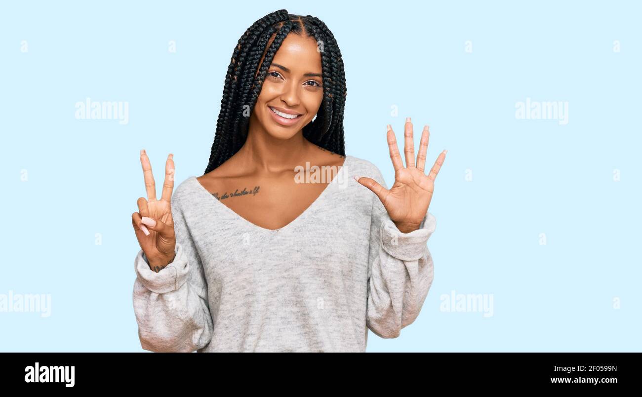 Beautiful hispanic woman wearing casual clothes showing and pointing up ...