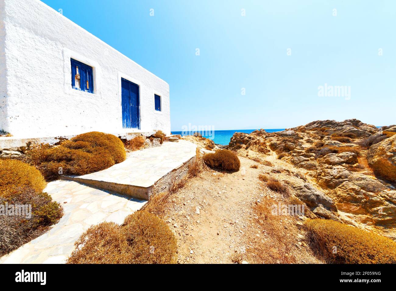 Rock sea and mykonos island blue Stock Photo - Alamy