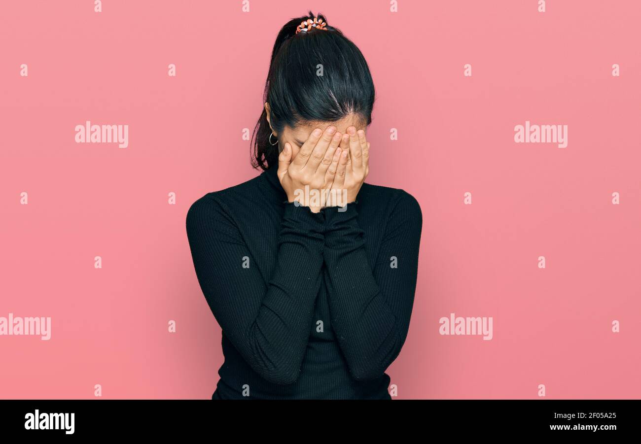 Young hispanic woman wearing casual clothes with sad expression ...