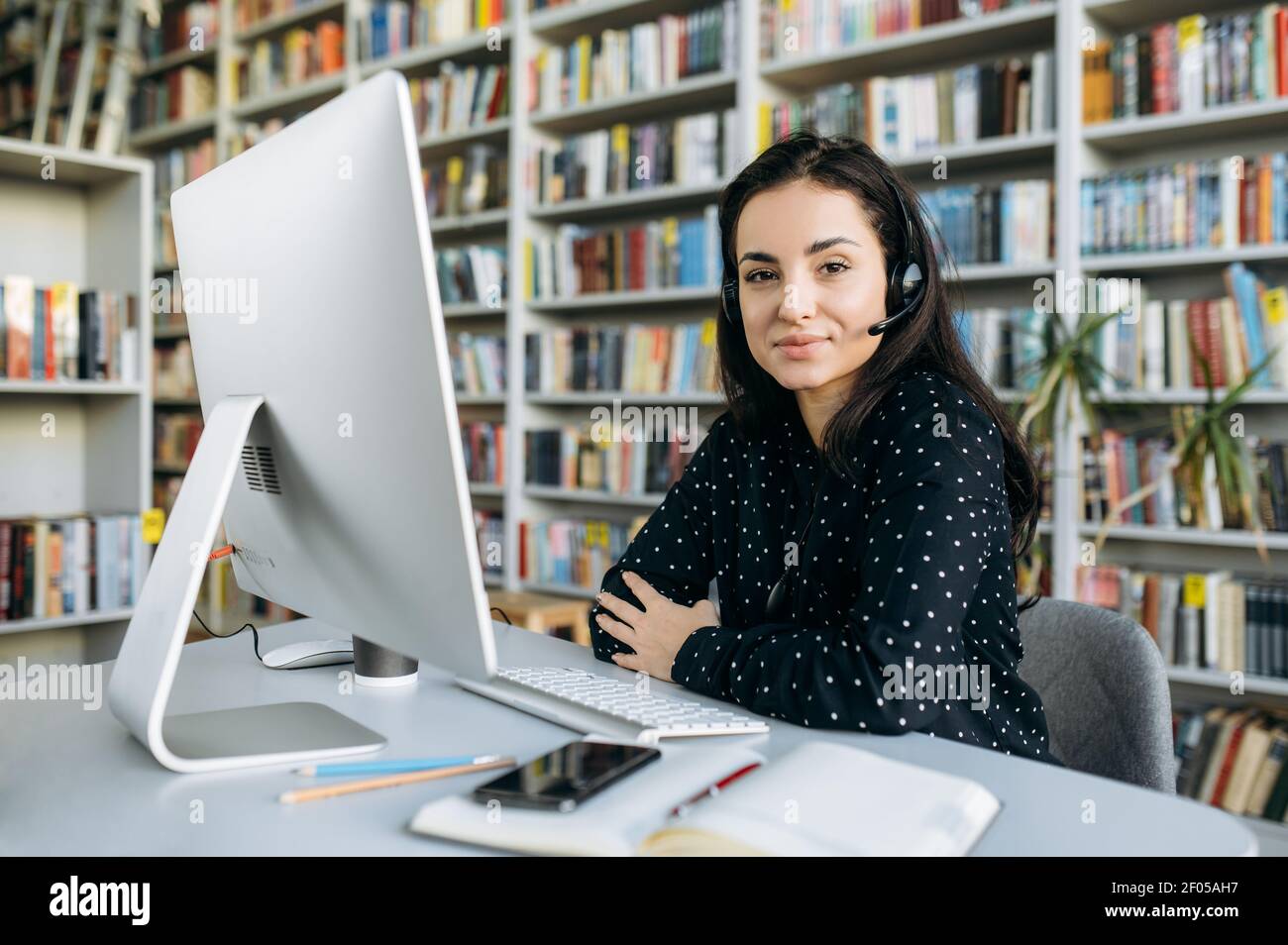 Caucasian stylish lady sit at the desk, working in support service ...