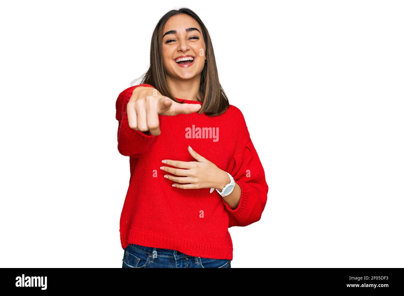 Beautiful brunette woman wearing casual winter sweater laughing at you ...