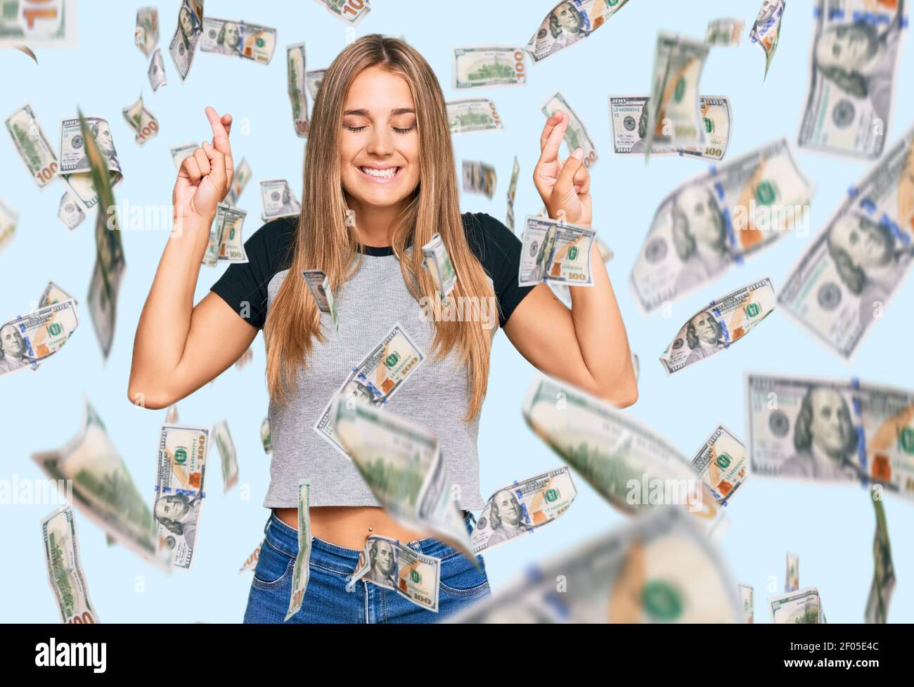 Woman fingers crossed money hi-res stock photography and images - Alamy