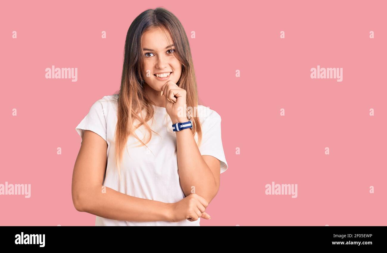 Beautiful caucasian woman wearing casual white tshirt looking confident ...