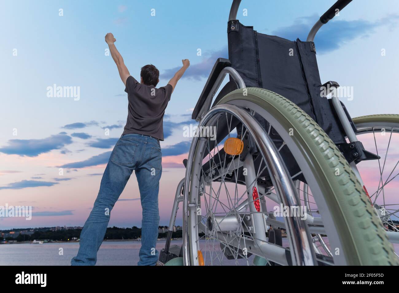 Disabled handicapped man is healthy again. He is happy and standing ...