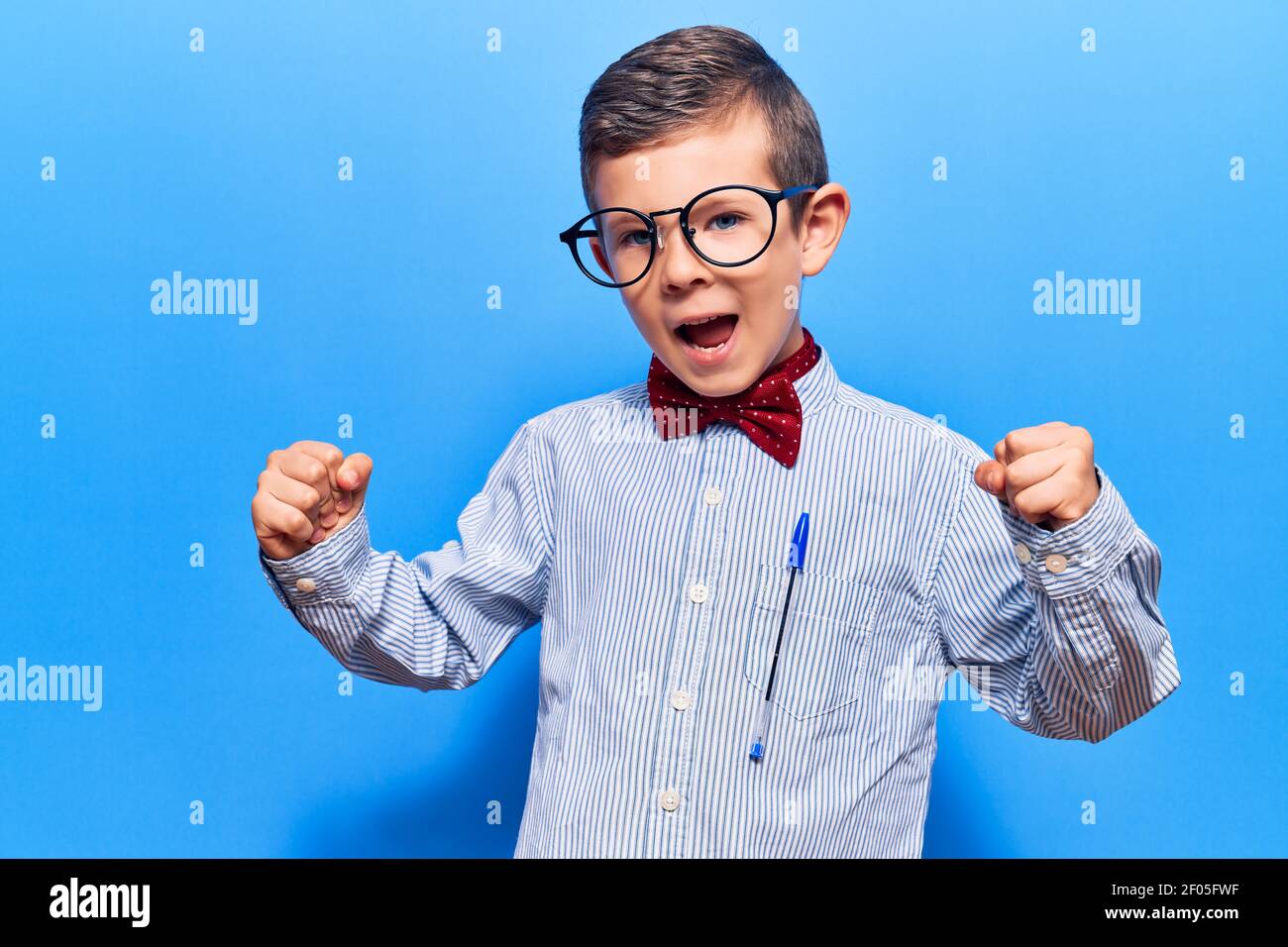 Cute blond kid wearing nerd bow tie and glasses celebrating surprised ...