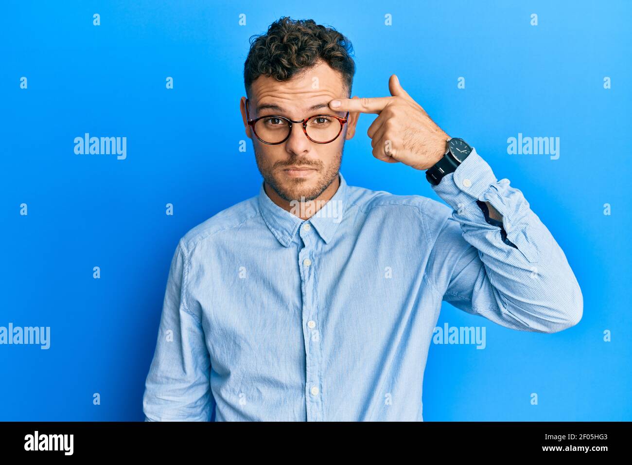Young hispanic man wearing casual clothes and glasses pointing unhappy ...