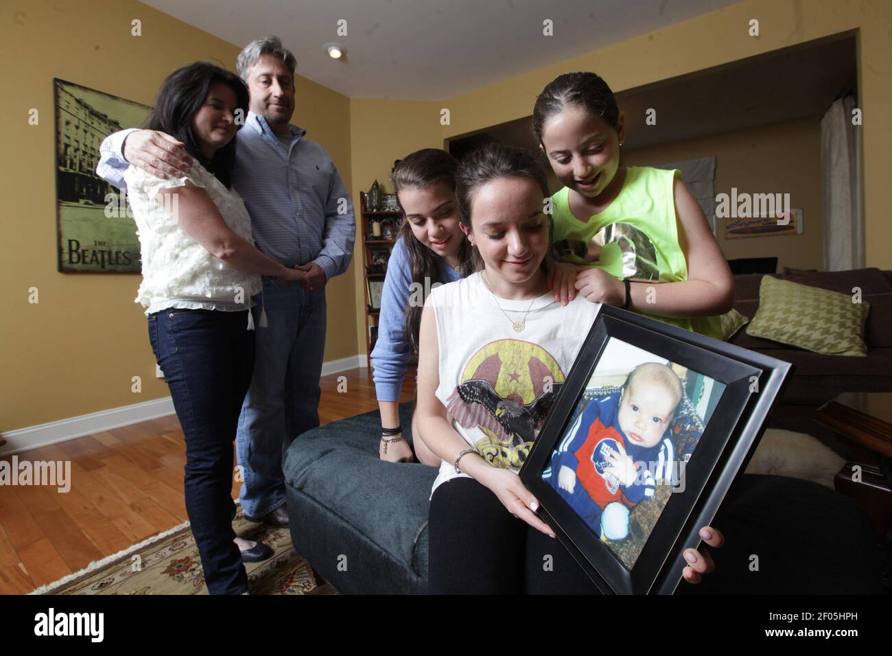 The Davis Family display a photo of baby Garret, who died at the age of ...