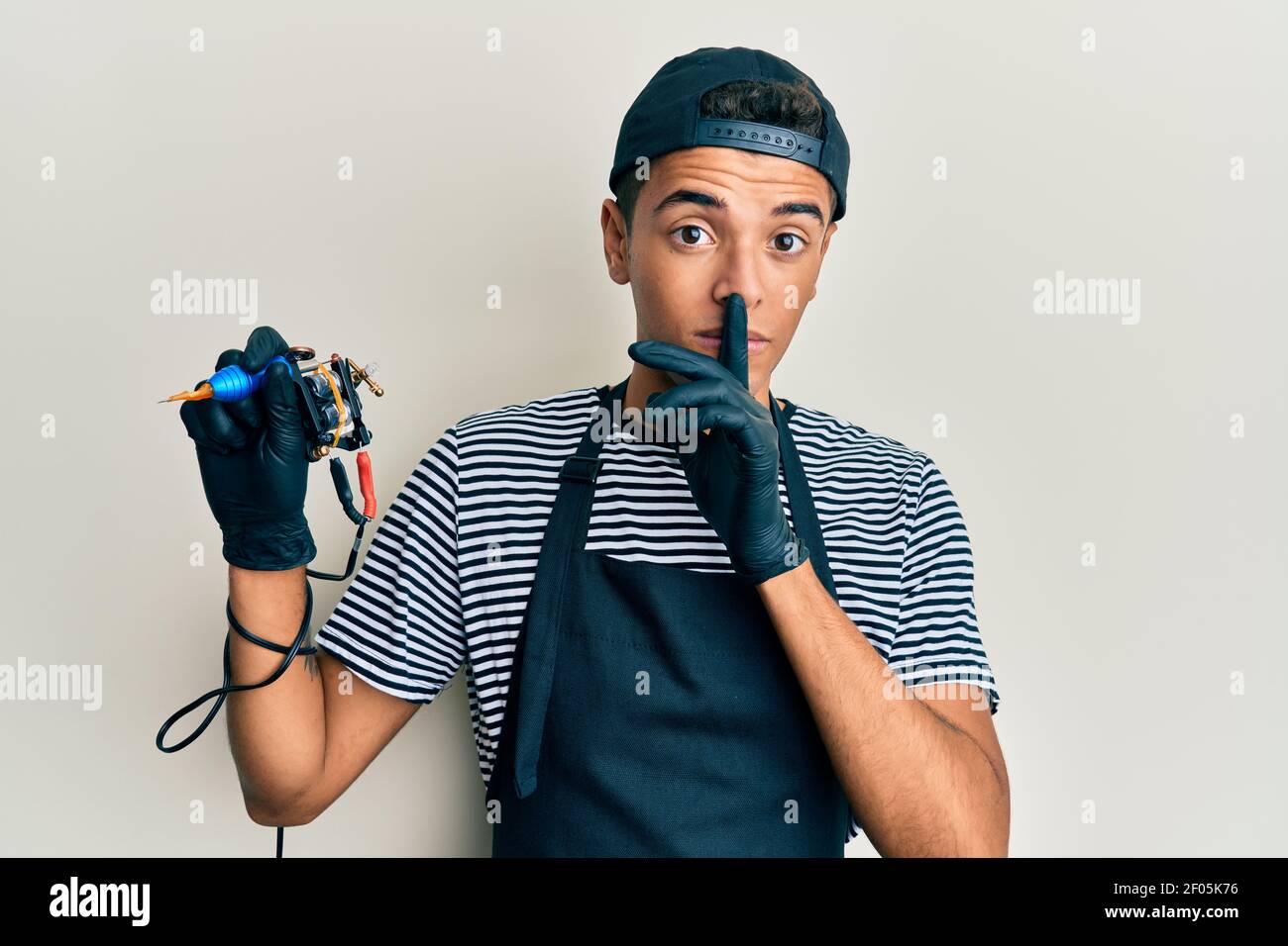 Young handsome african american man tattoo artist wearing professional ...