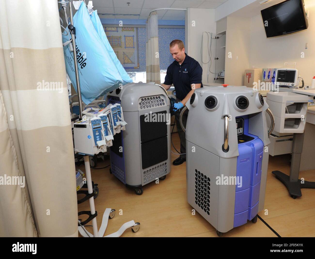 Mike Duclos sets up two disinfecting "robots," machines that vaporize ...