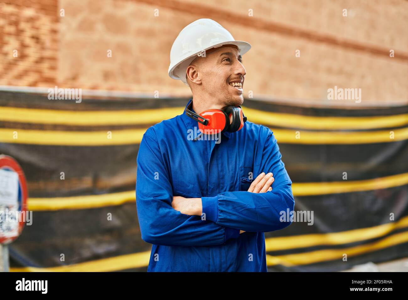 Young caucasian worker smiling happy wearing uniform at the city Stock ...