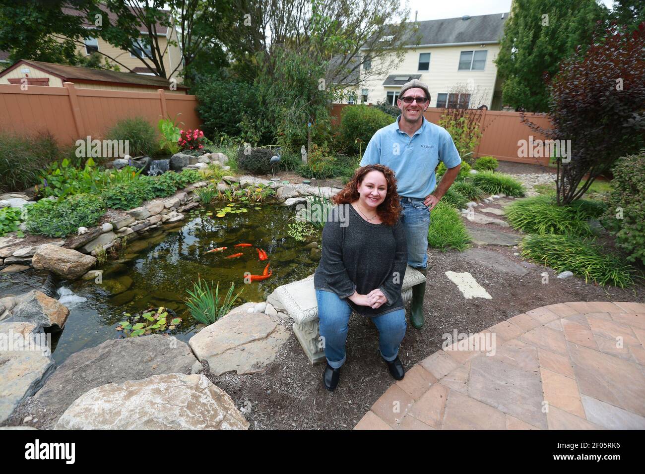 Laura and Matt Reale pose for a portrait with the pond installed by ...