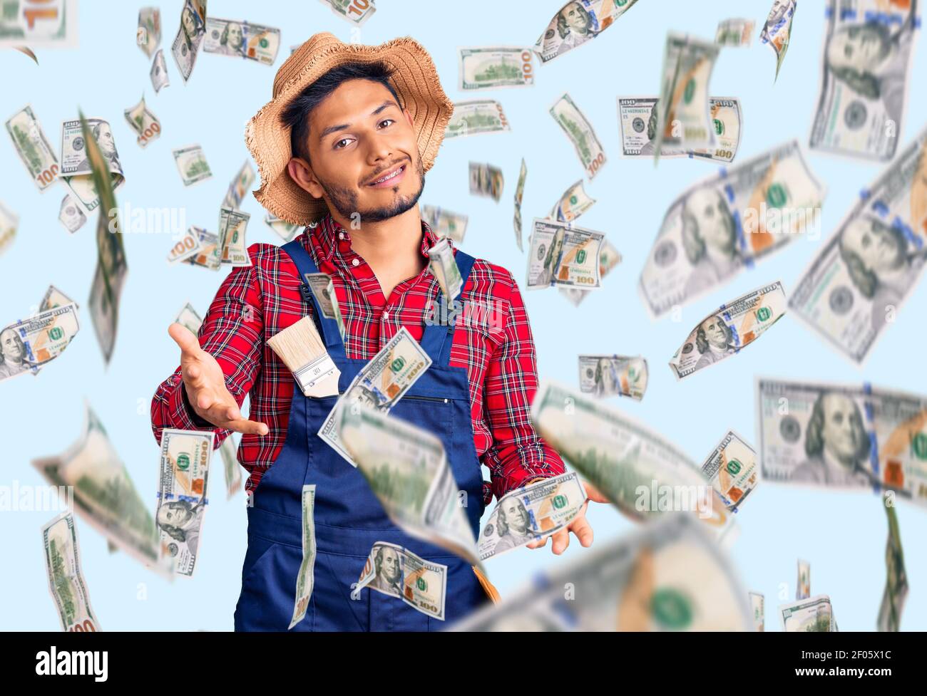 Handsome latin american young man weaing handyman uniform smiling ...