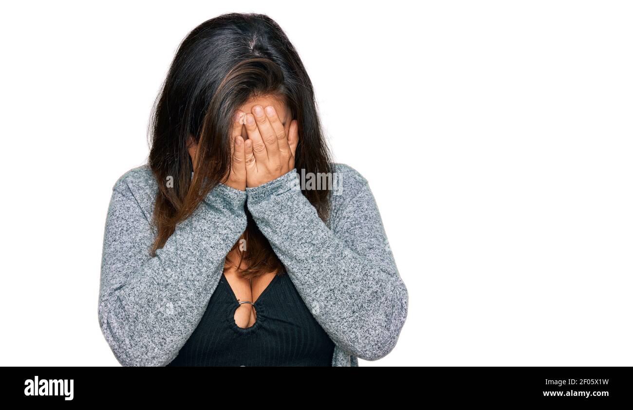 Beautiful hispanic woman wearing casual clothes with sad expression ...