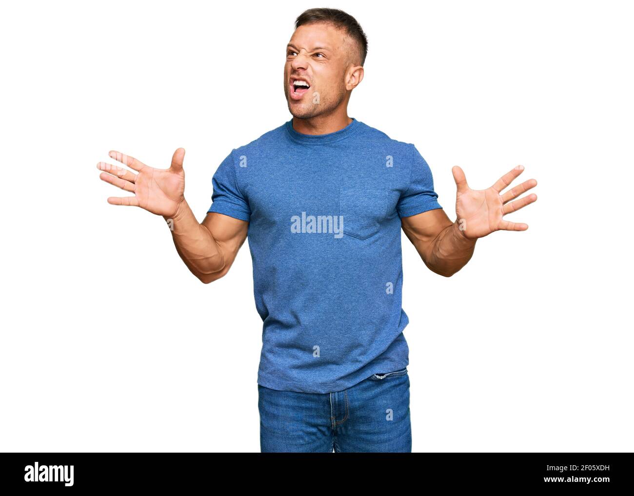 Handsome muscle man wearing casual clothes crazy and mad shouting and ...