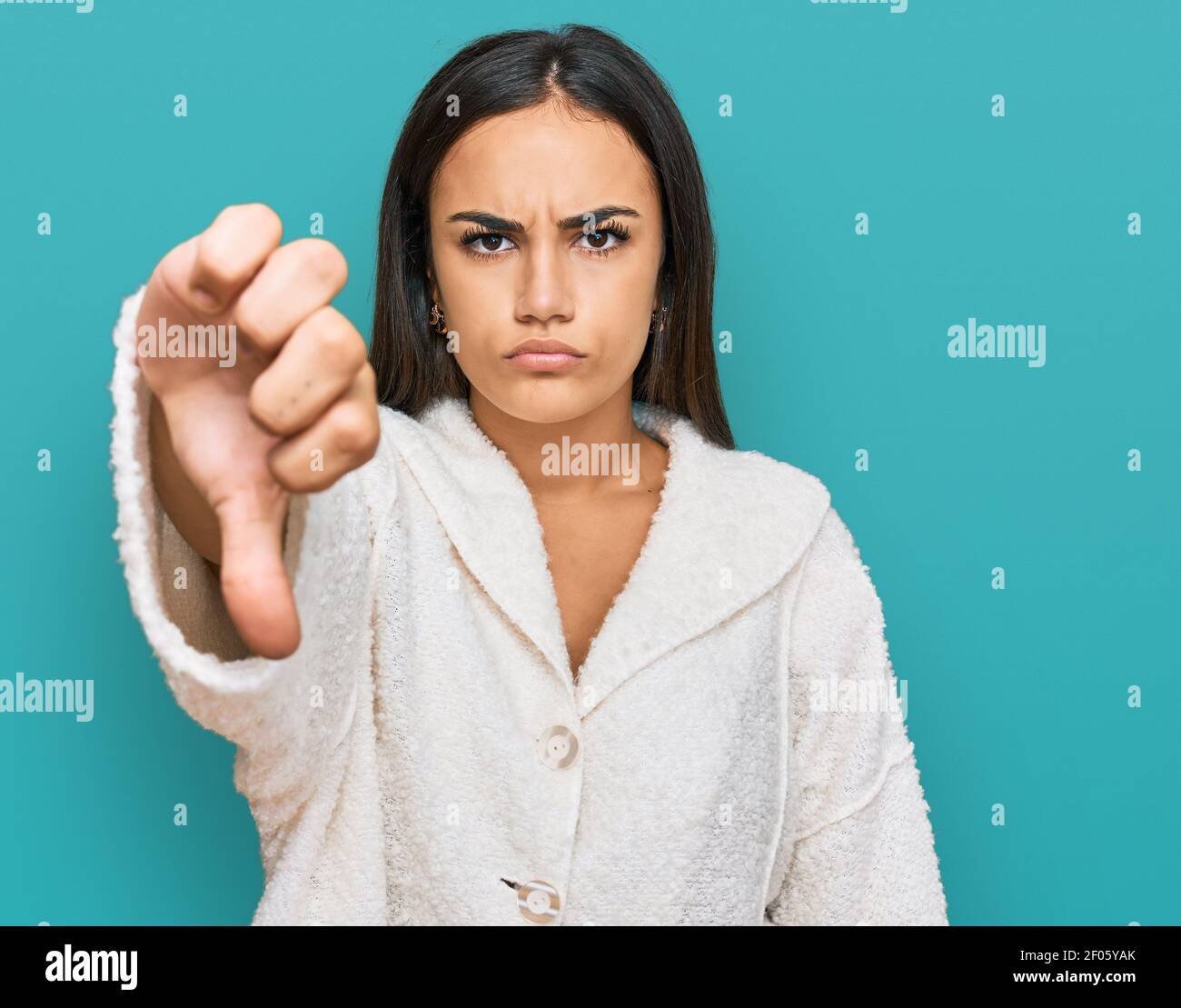 Young brunette woman wearing casual clothes looking unhappy and angry ...
