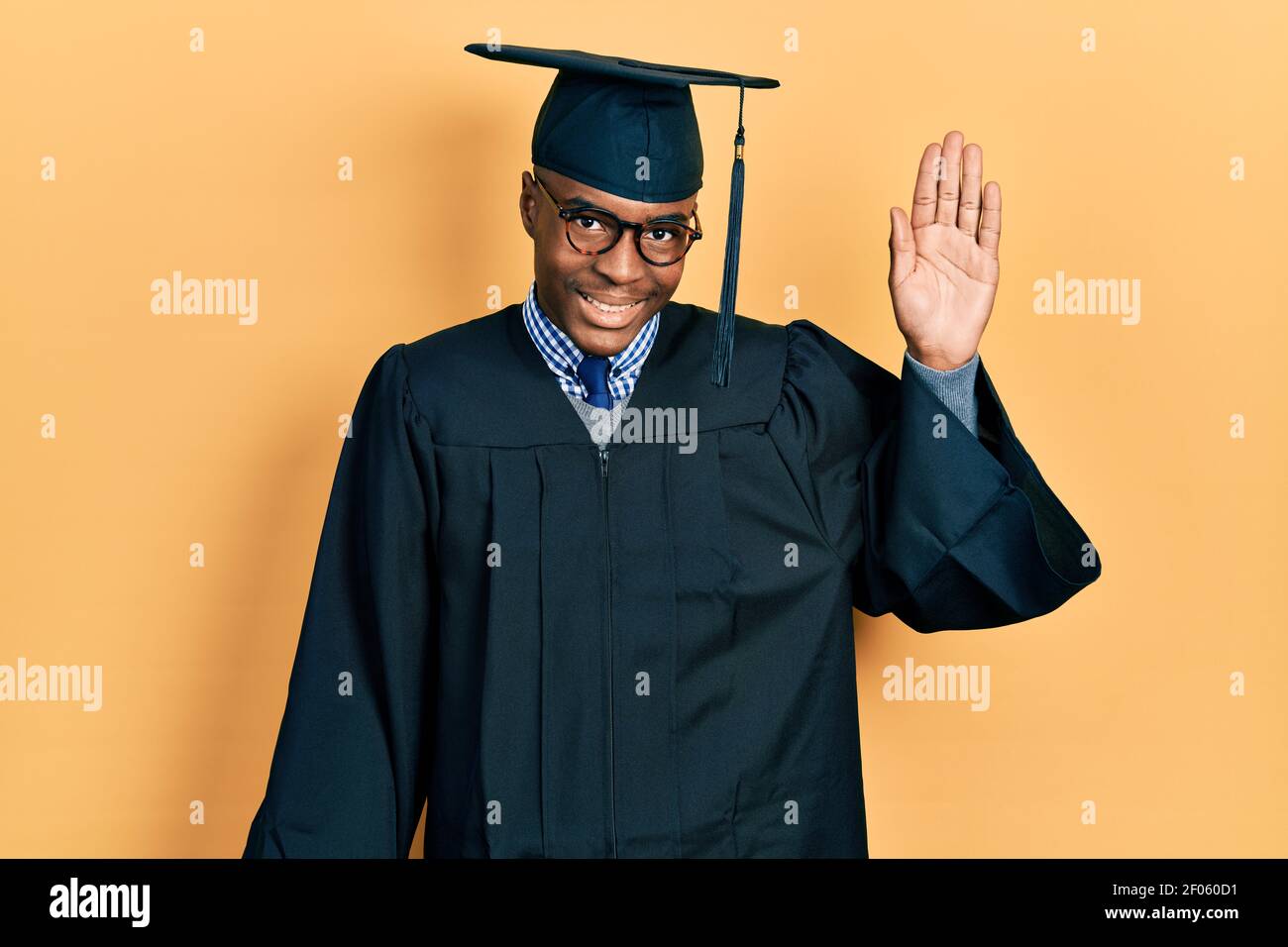 Young african american man wearing graduation cap and ceremony robe ...