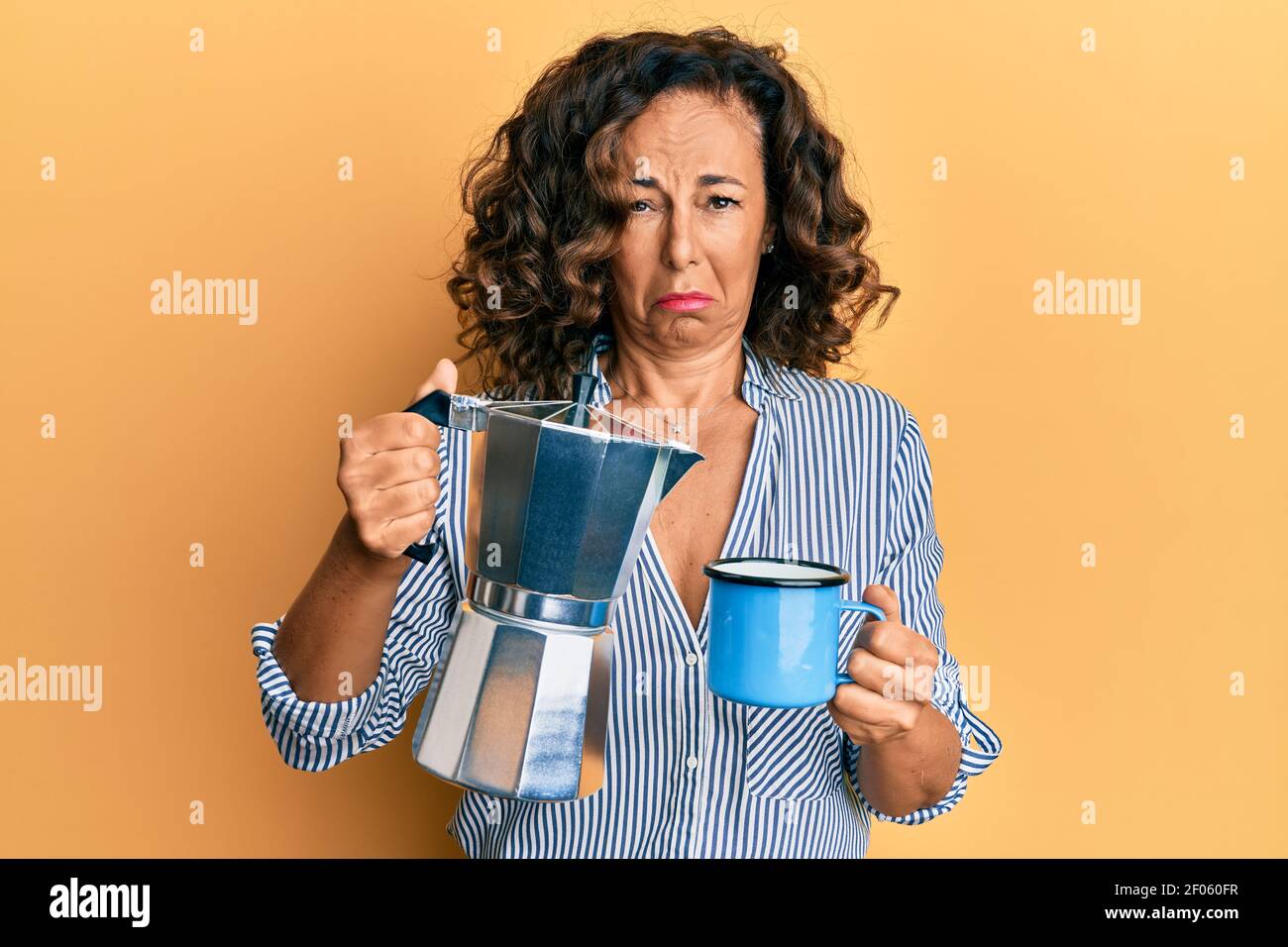 Middle age hispanic woman drinking italian coffee depressed and worry ...