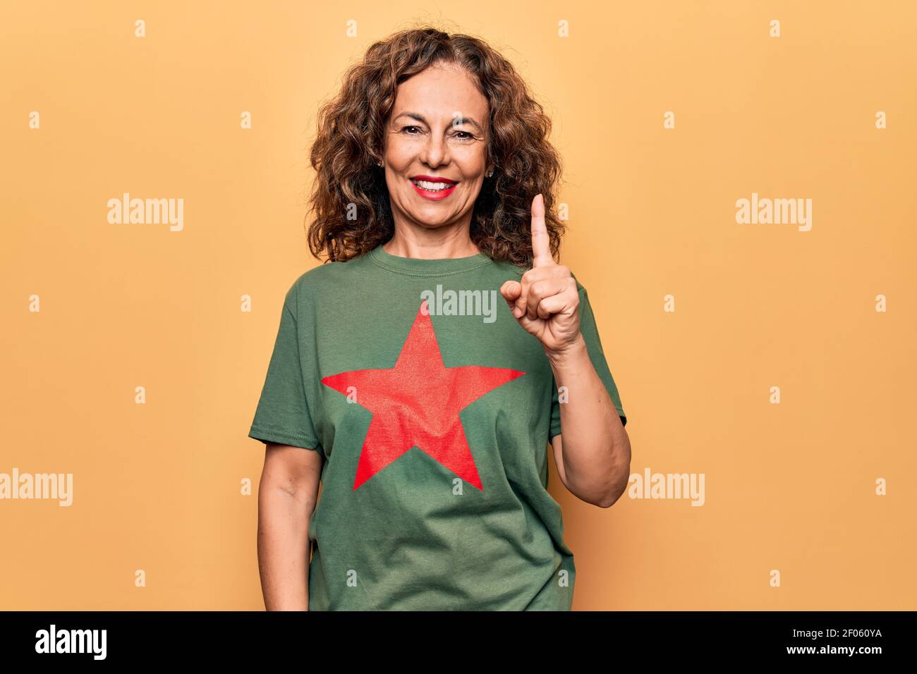 Middle age beautiful woman wearing t-shirt with red star revolutionary ...
