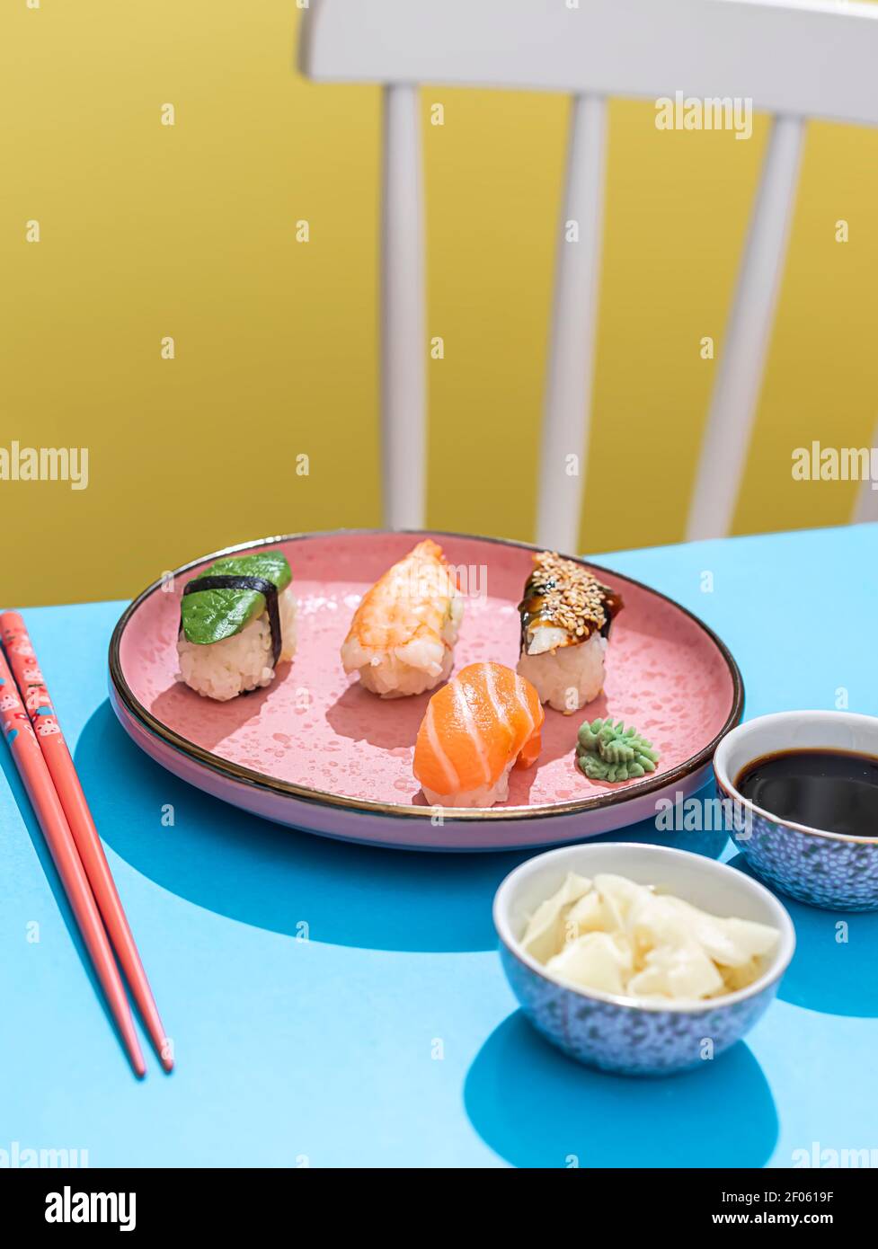 Set of nigiri sushi served on plate on a colorful background. Hard ...