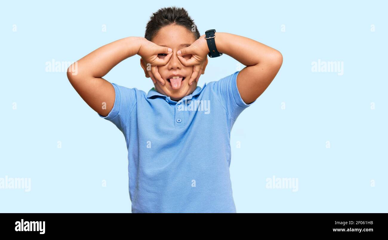 Little boy hispanic kid wearing casual clothes doing ok gesture like ...