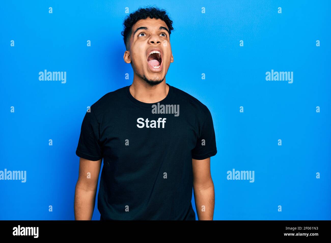 Young african american man wearing staff t shirt angry and mad ...