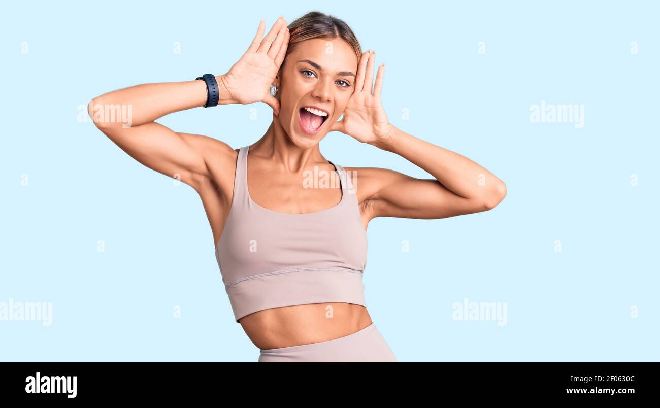 Beautiful caucasian woman wearing sportswear smiling cheerful playing ...