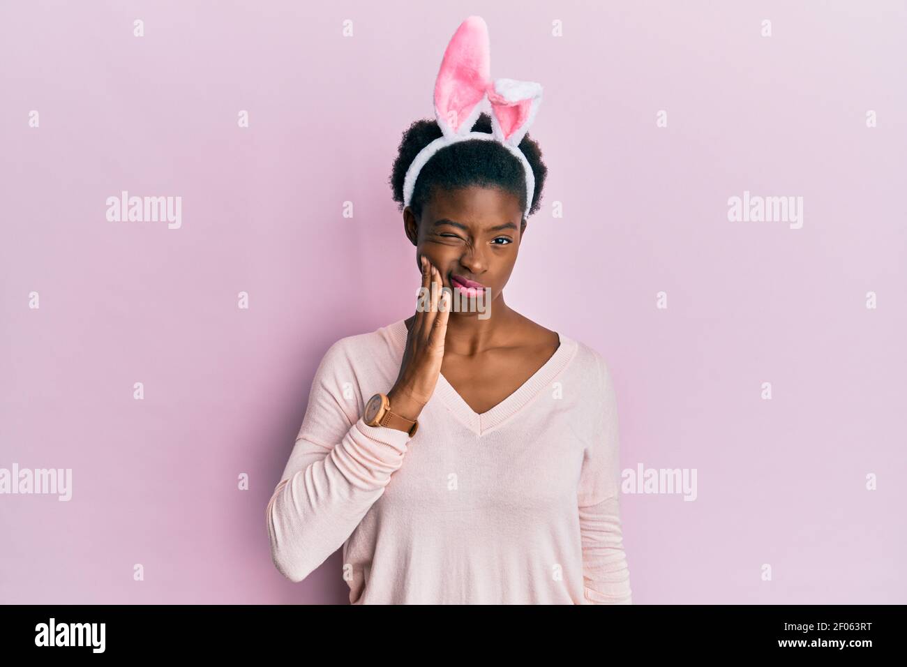 Young african american girl wearing cute easter bunny ears touching ...