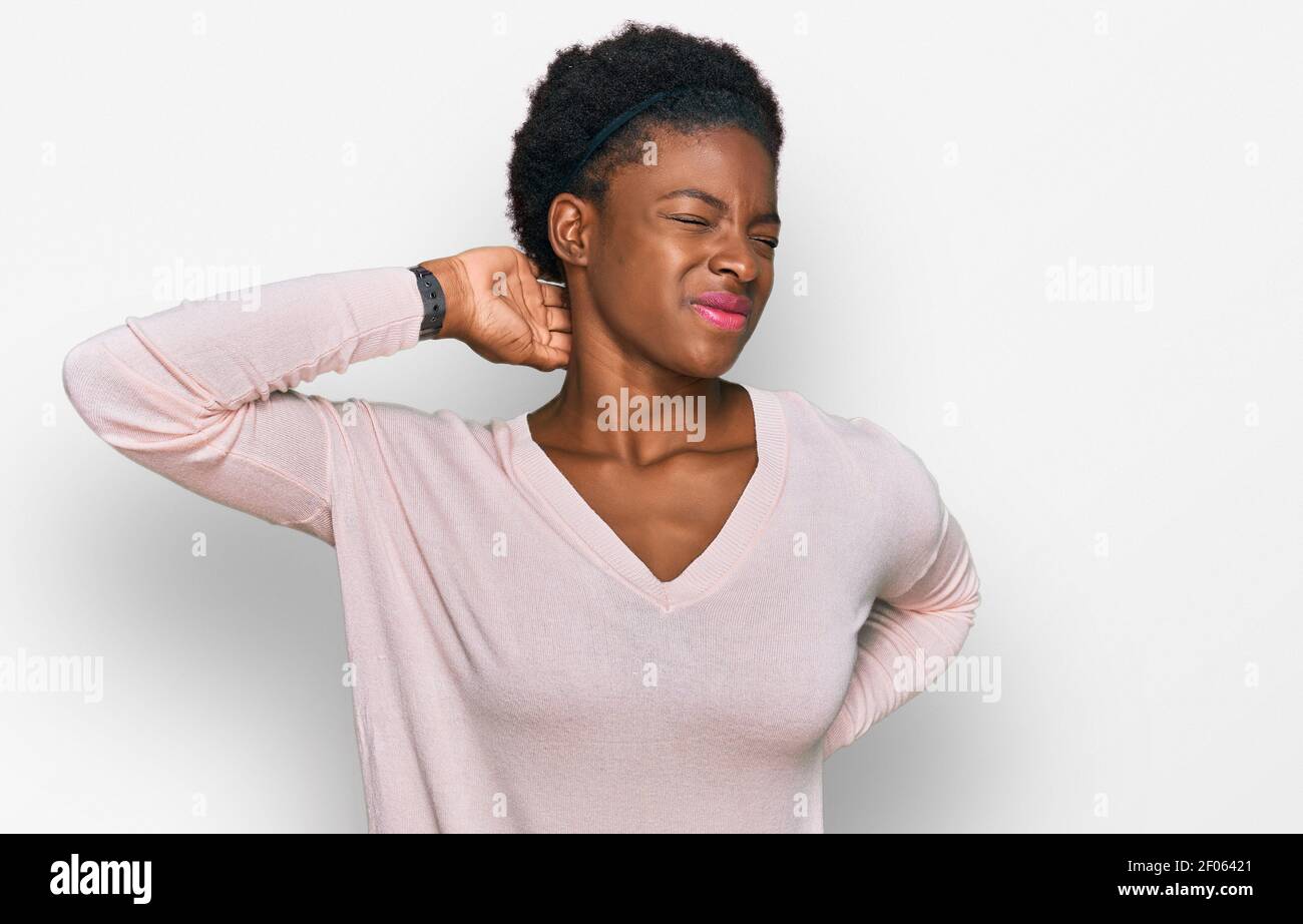 Young african american girl wearing casual clothes suffering of neck ...