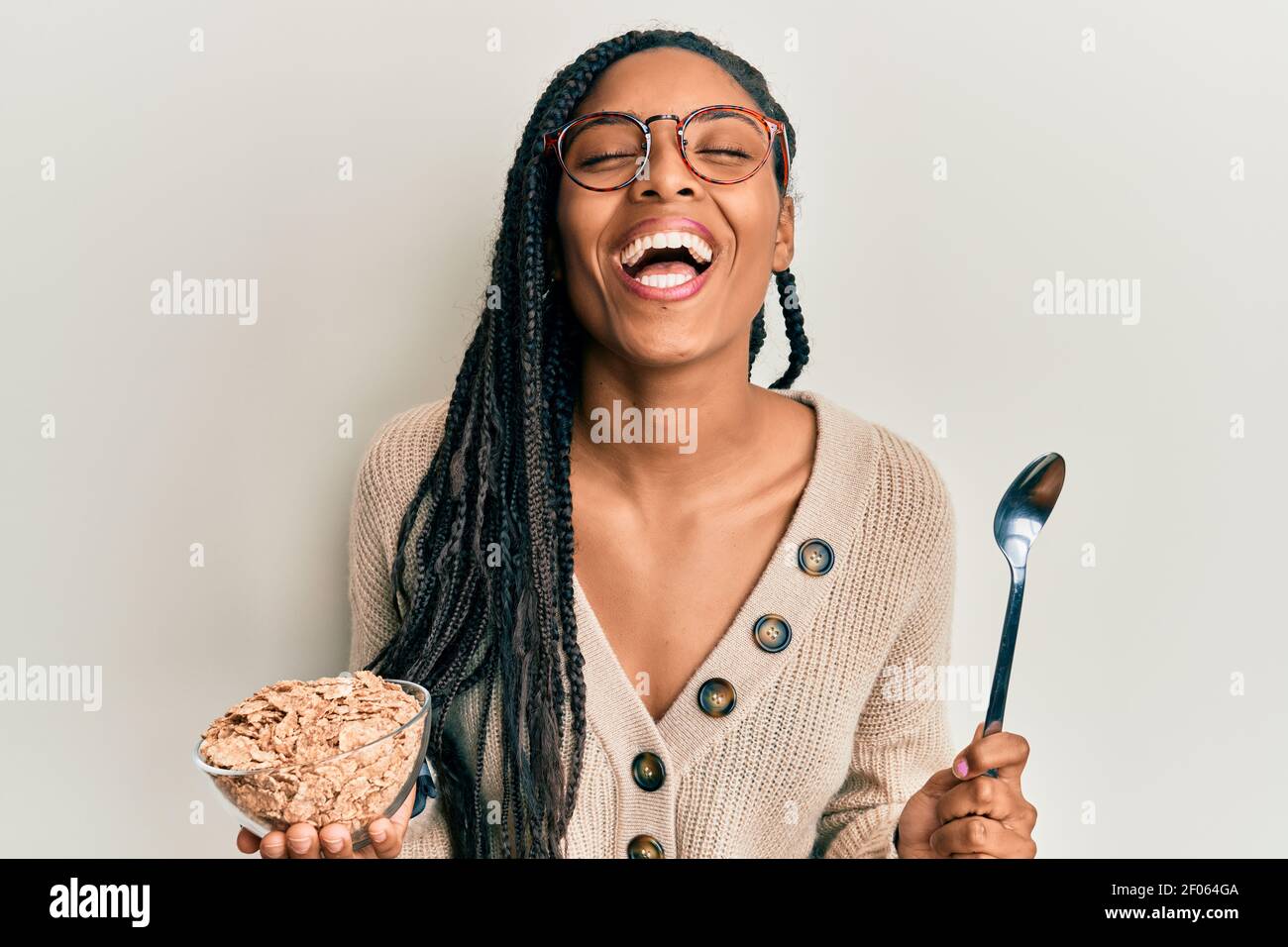 African american woman with braids eating healthy whole grain cereals ...