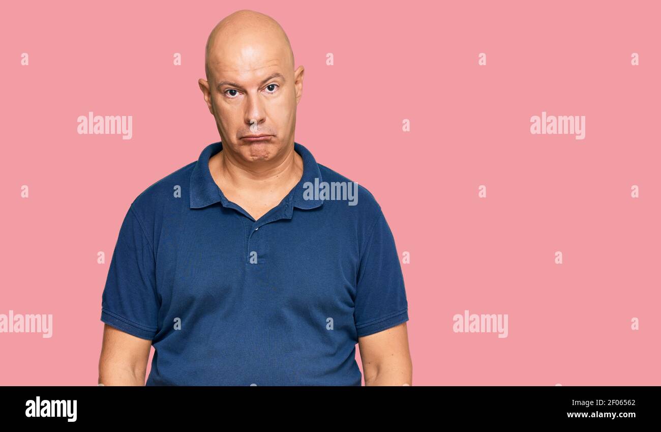 Middle age bald man wearing casual clothes depressed and worry for ...