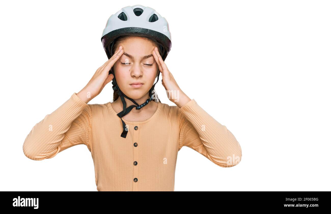 Beautiful brunette little girl wearing bike helmet suffering from ...