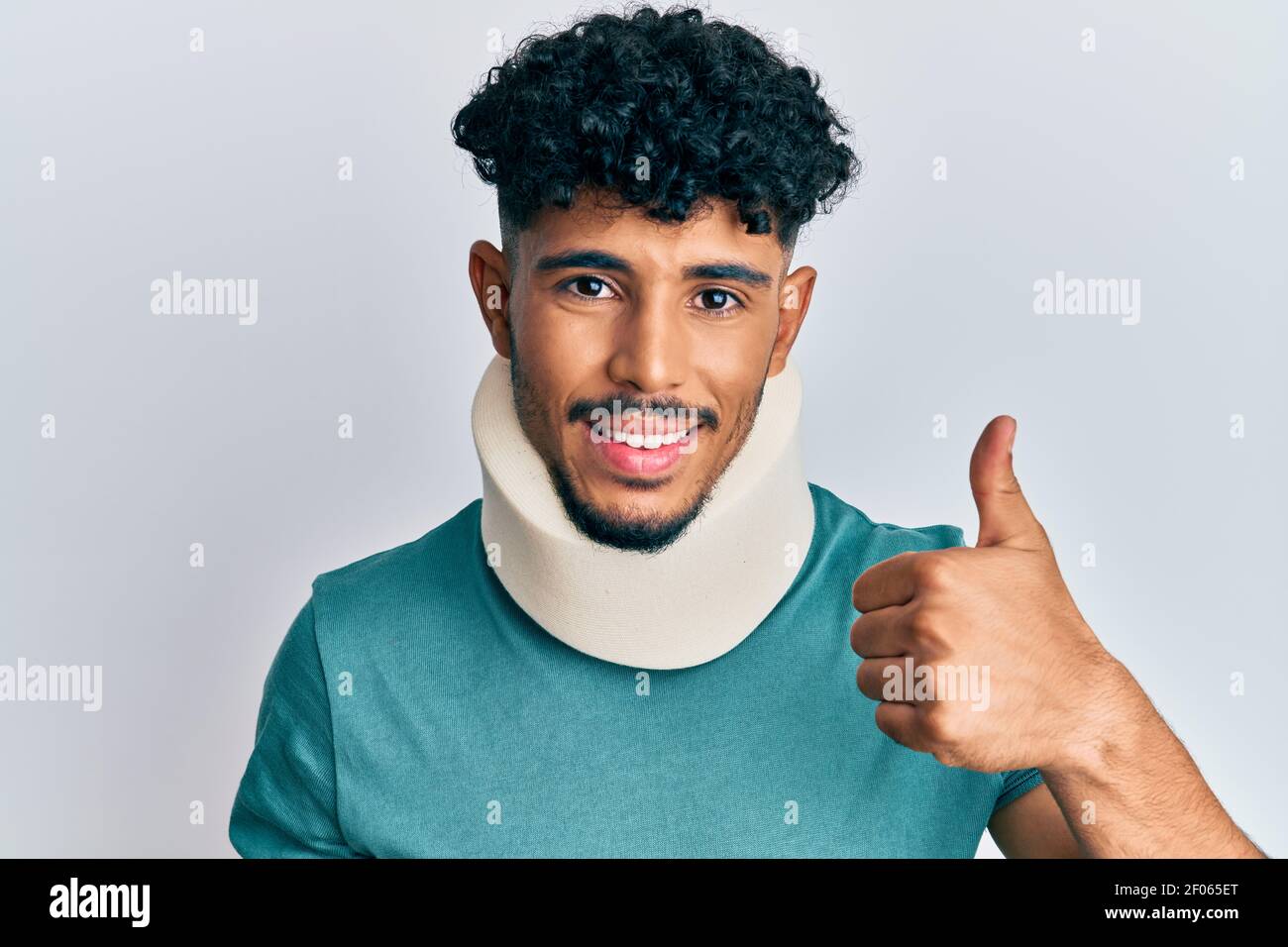 Young arab handsome man wearing cervical neck collar smiling happy and ...