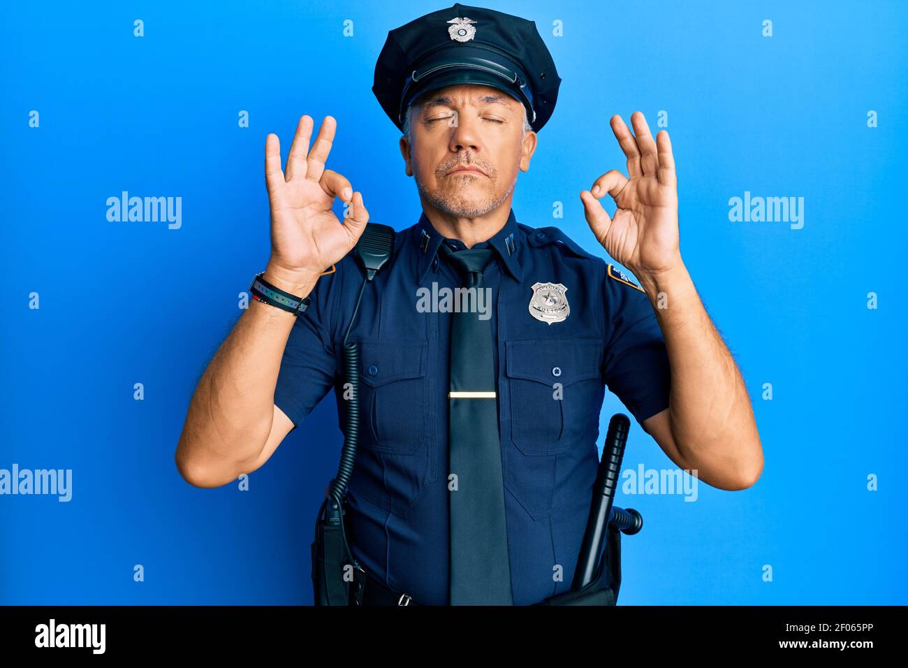 Handsome middle age mature man wearing police uniform relaxed and ...