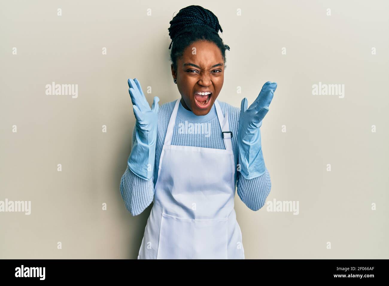 African american woman with braided hair wearing cleaner apron and ...