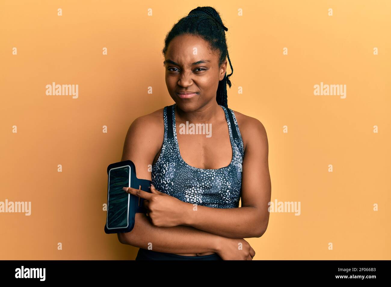 African American Woman With Braided Hair Wearing Sportswear Using Arm